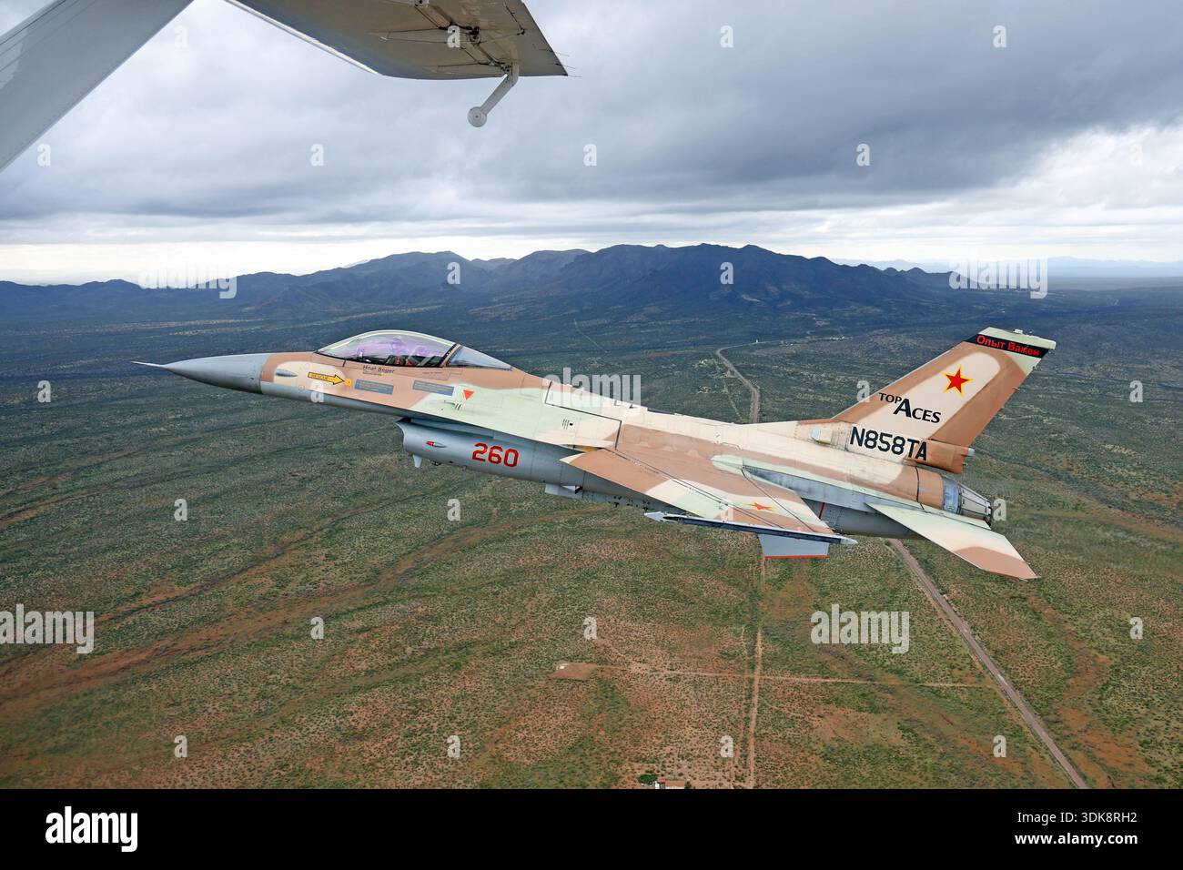 A Top Aces General Dynamics F-16A Netz is depicted in air-to-air flight ...