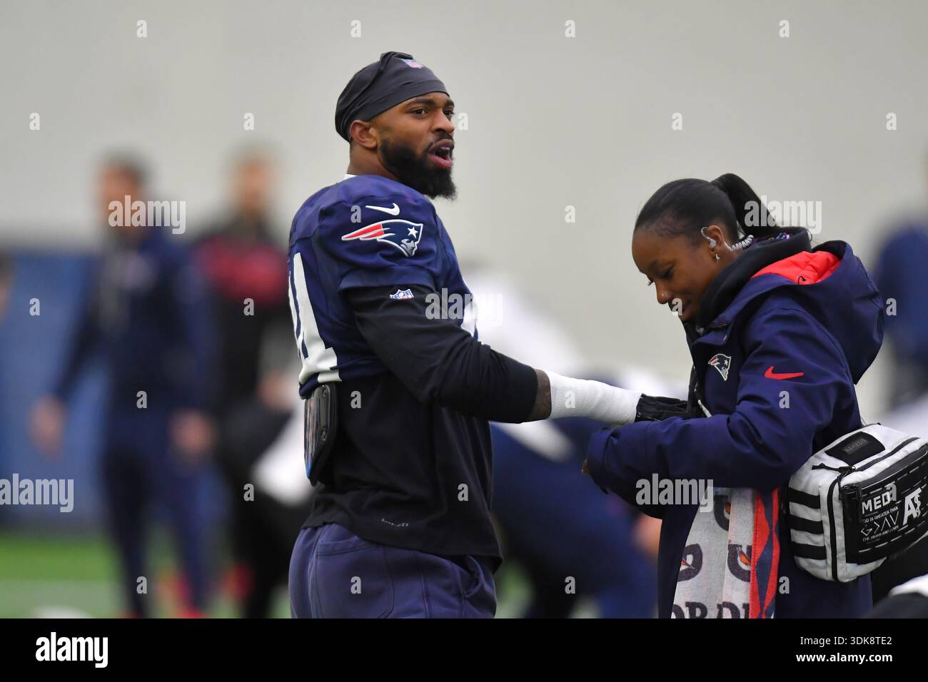 New England Patriots linebacker K'lavon Chaisson, left, has his arm ...