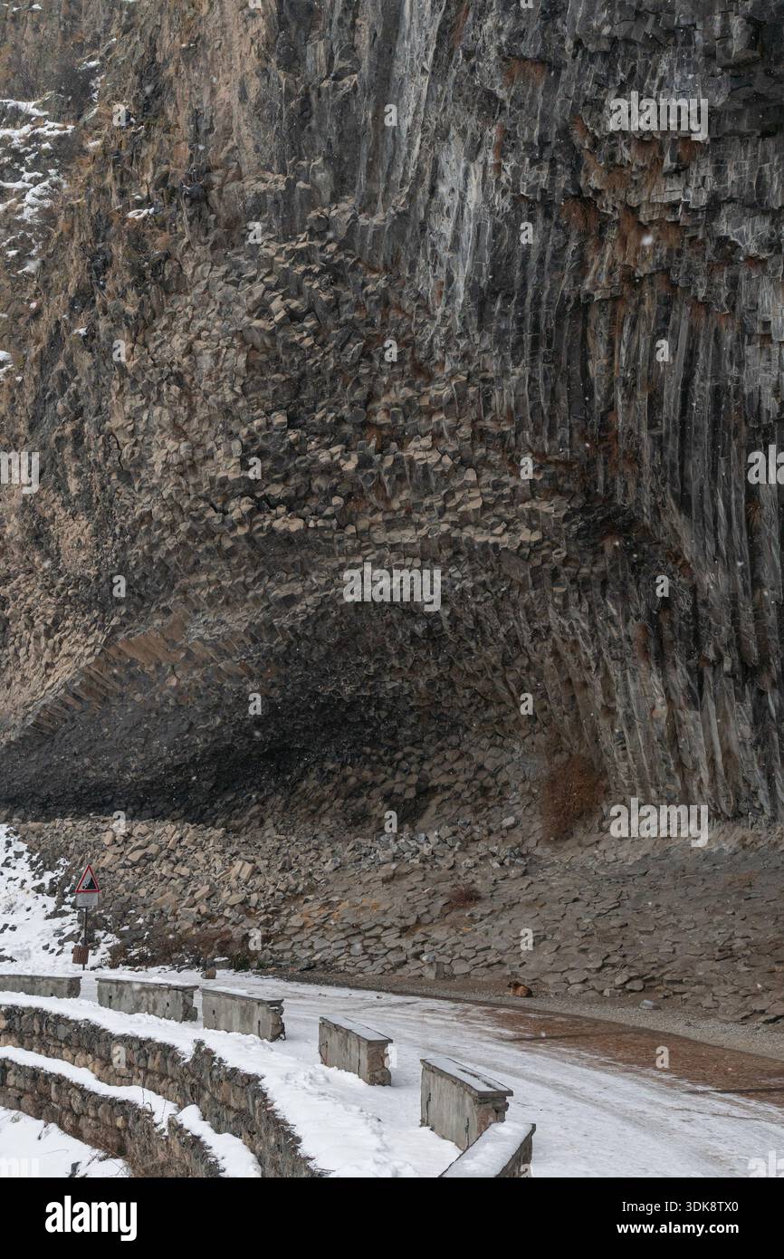 Snow-covered road curves along massive basalt cliffs at Symphony of ...