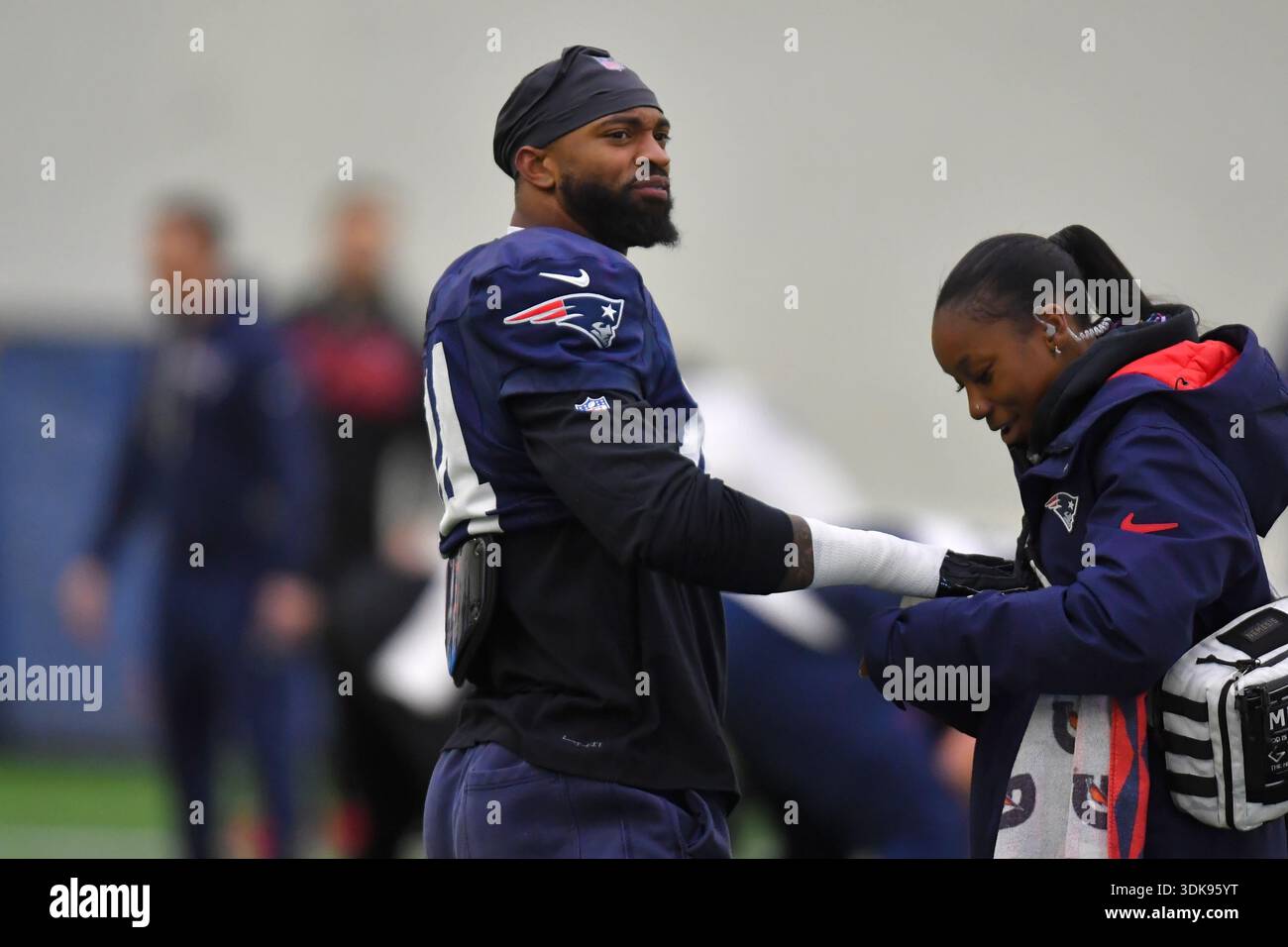 New England Patriots linebacker K'lavon Chaisson, left, has his arm ...