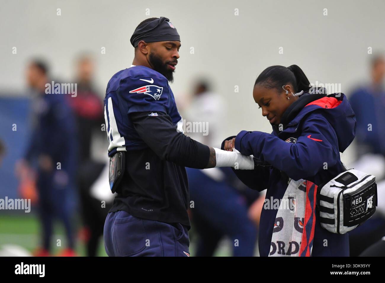 New England Patriots linebacker K'lavon Chaisson, left, has his arm ...