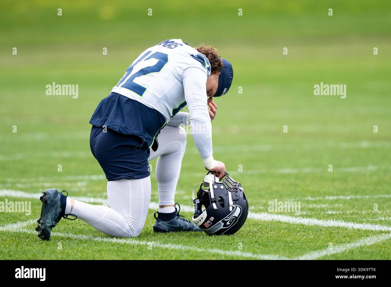 Seattle Seahawks linebacker Drake Thomas kneels on the field during an ...