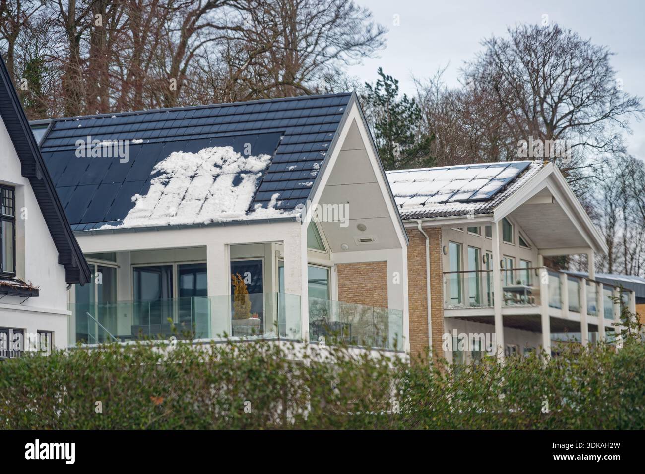 Residential buildings with remaining snow on roofs after winter storm ...