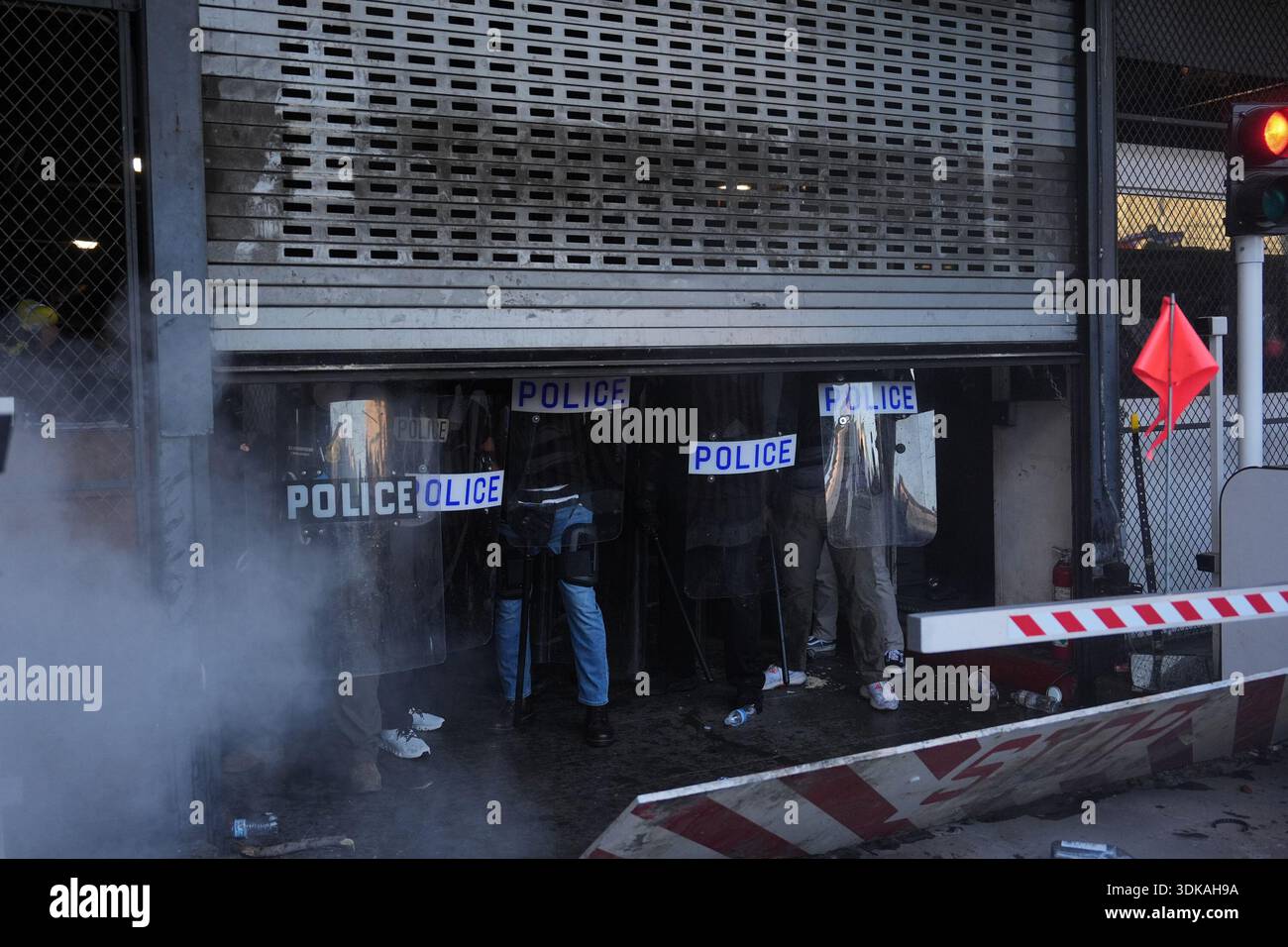 Federal police block protesters along a loading dock at the ...