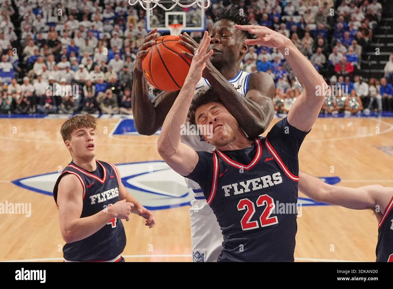 Dayton's Damon Friery (22) and Saint Louis' Paul Otieno reach for a ...
