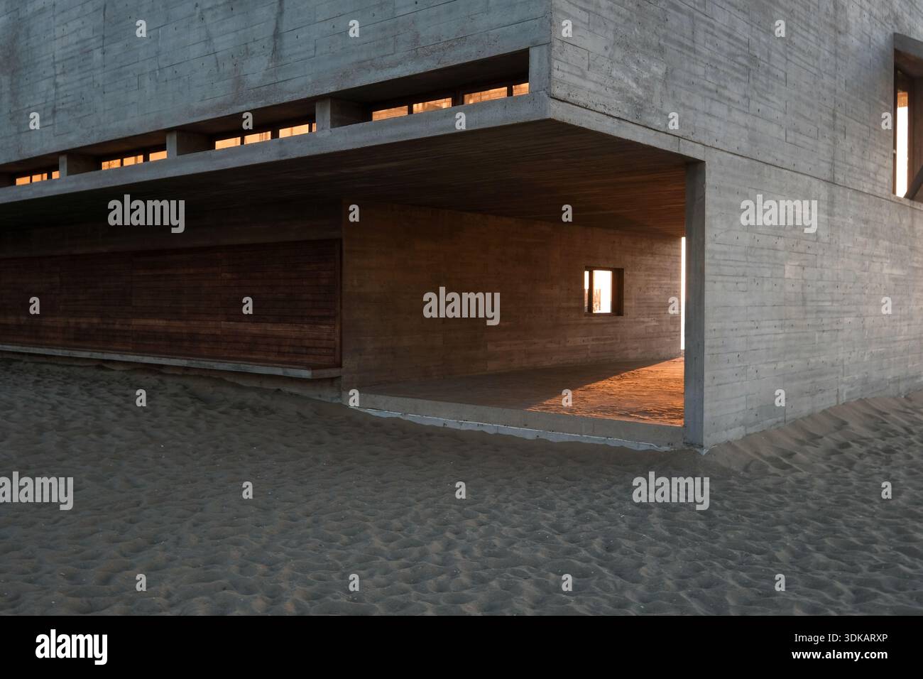 A detailed shot of a modern concrete building's open ground floor and ...