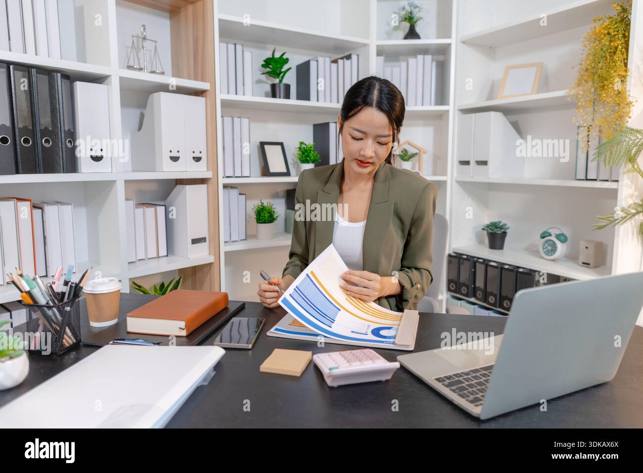 Professional woman concentrating on office work while managing tasks ...