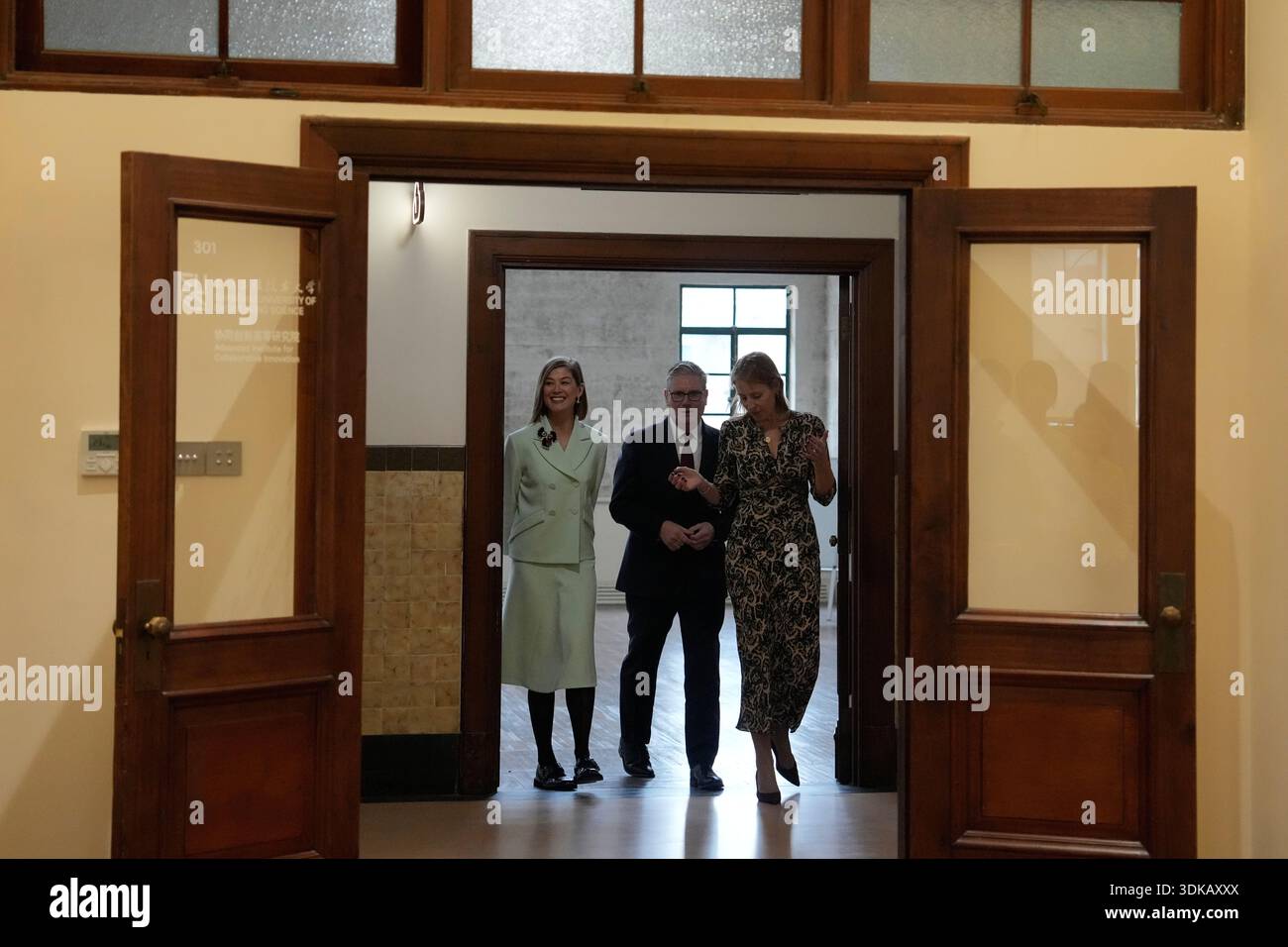 Britain's Prime Minister Keir Starmer, center, Rosamund Pike, left, and ...