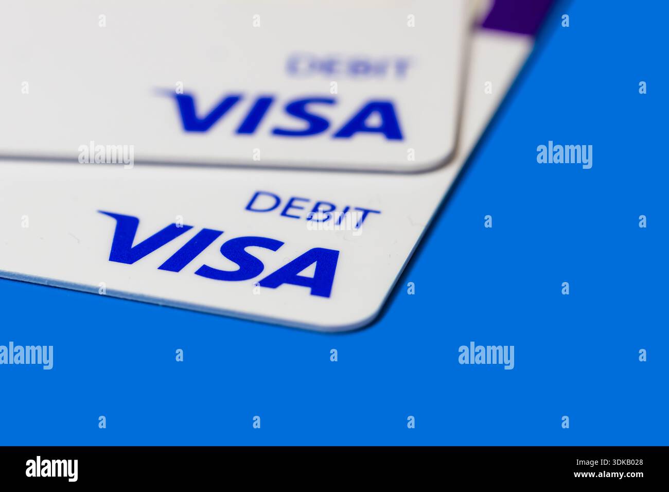 Detroit, Michigan -December 29, 2025: Two Visa bank Debit cards on blue ...
