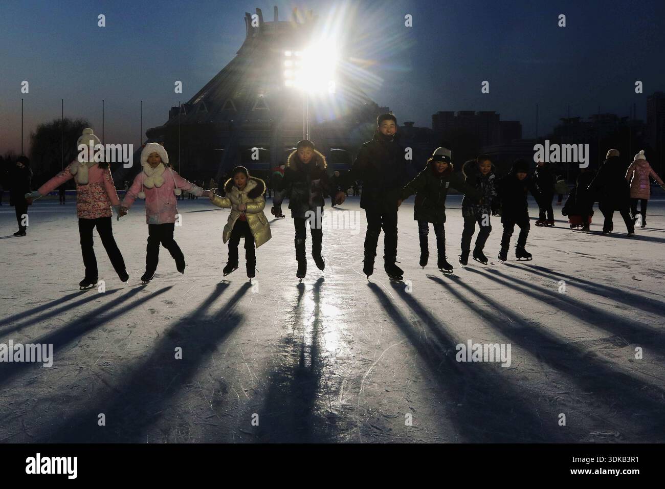 People including students and children skate at the outdoor rink of the ...