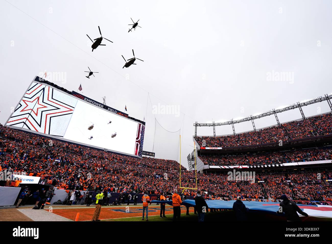 Helicopters fly over the stadium before an NFL football game between ...