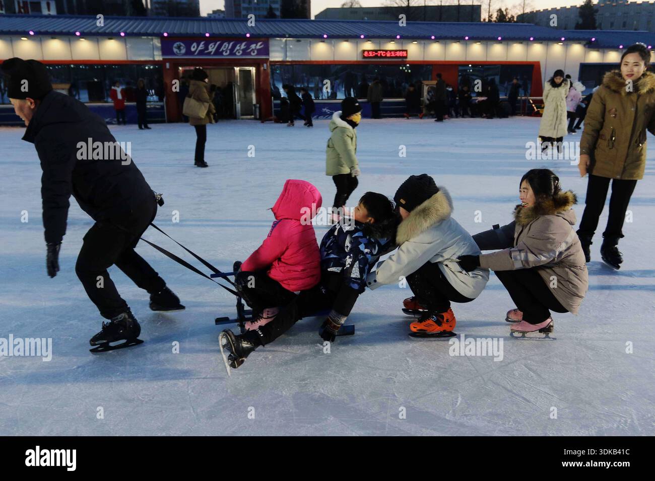 People including students and children skate at the outdoor rink of the ...