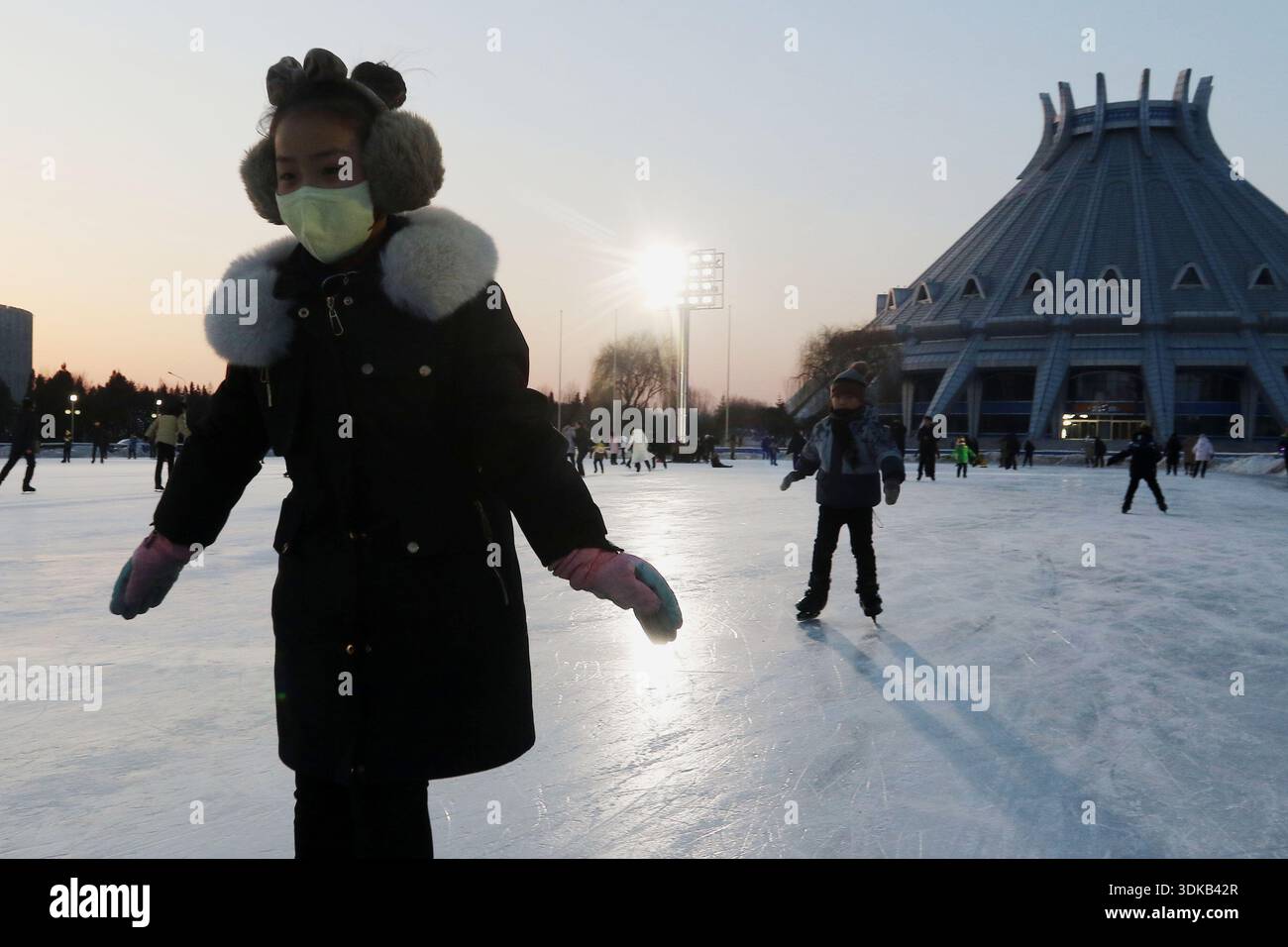 People including students and children skate at the outdoor rink of the ...