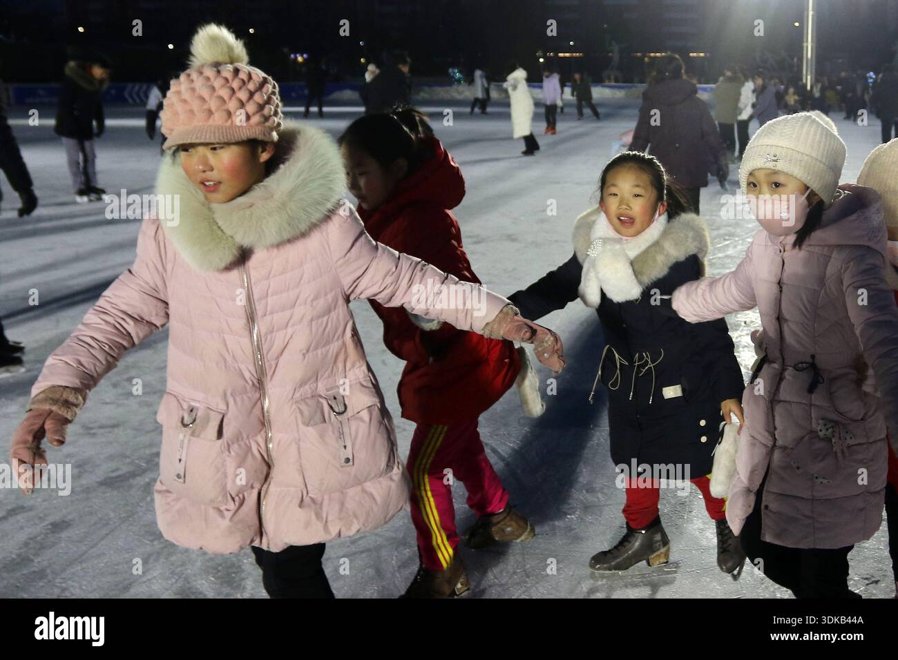 People including students and children skate at the outdoor rink of the ...