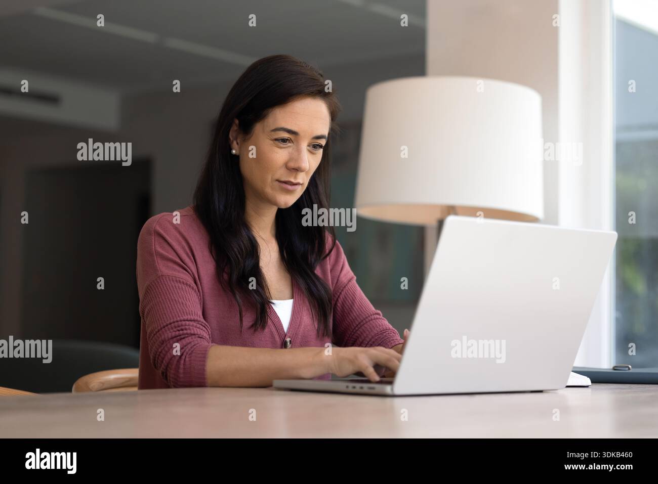 Woman working focused on laptop hi-res stock photography and images - Alamy