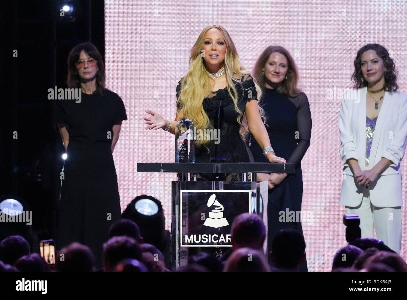Mariah Carey, center, accepts the 2026 MusiCares Persons of the Year ...