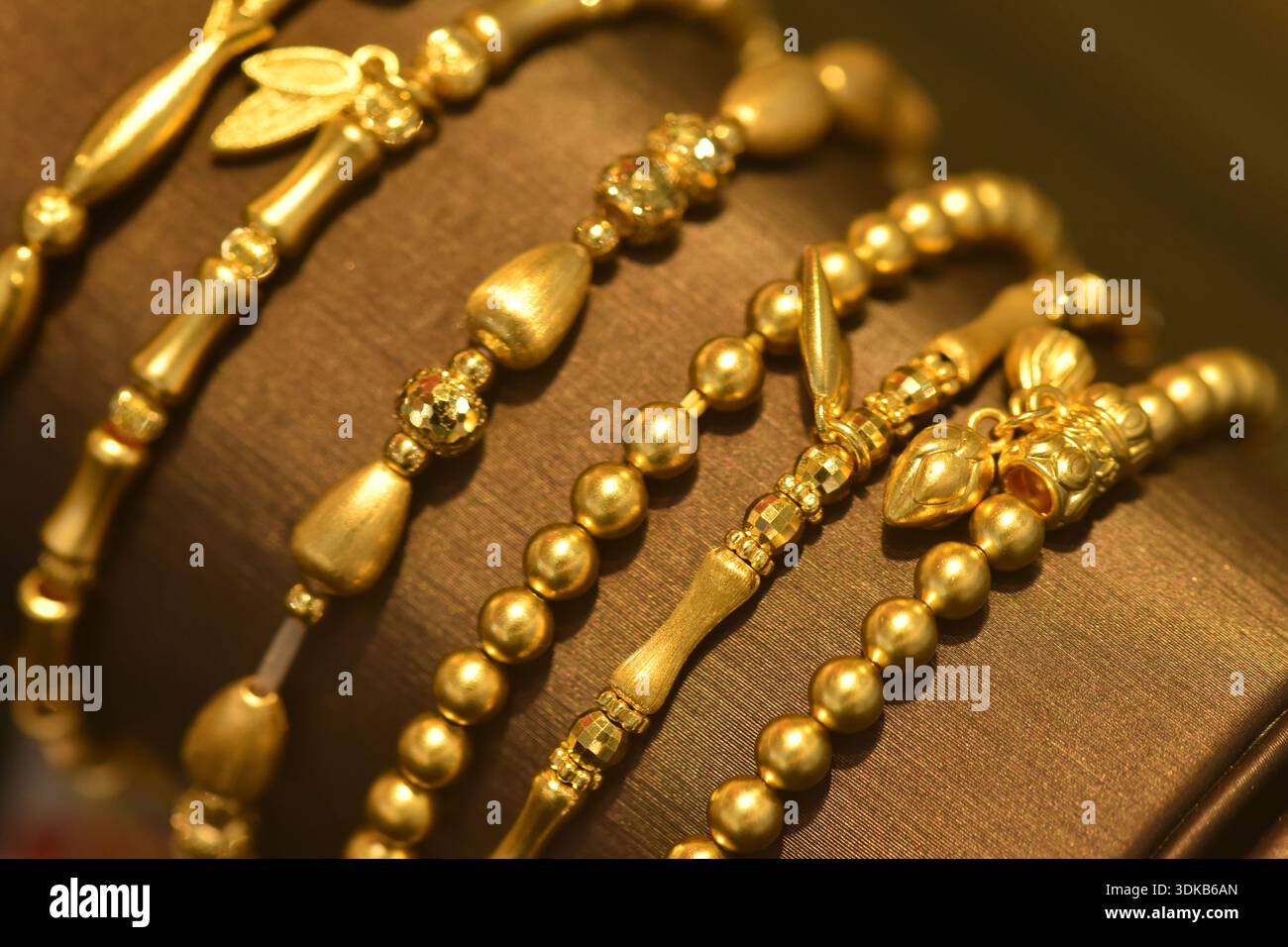 Gold jewelry being photographed in a gold shop in Fuyang City, Anhui ...