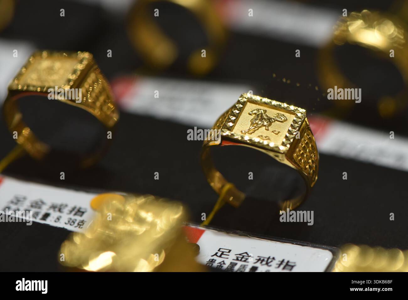 Gold jewelry being photographed in a gold shop in Fuyang City, Anhui ...