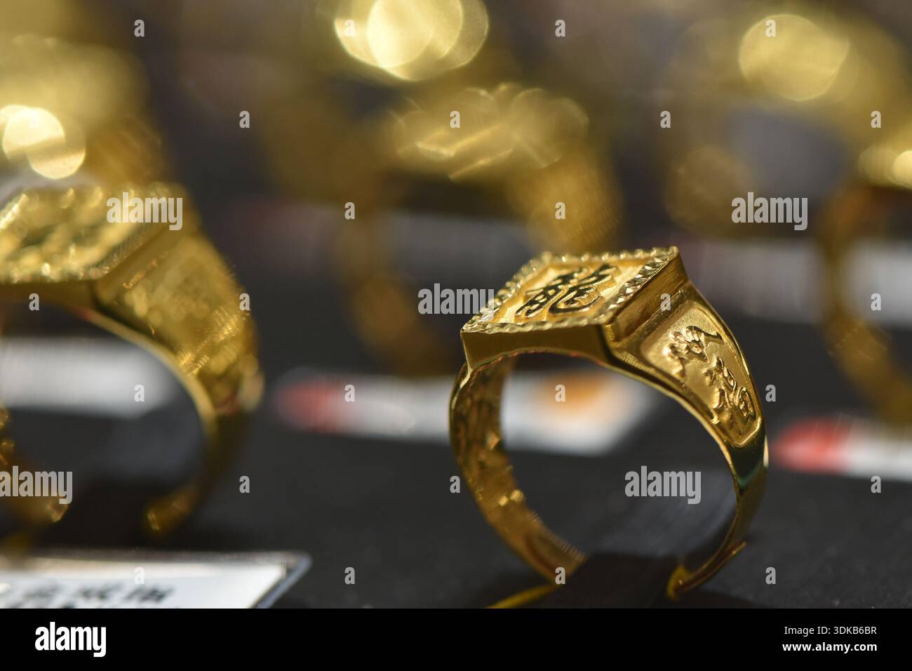 Gold jewelry being photographed in a gold shop in Fuyang City, Anhui ...