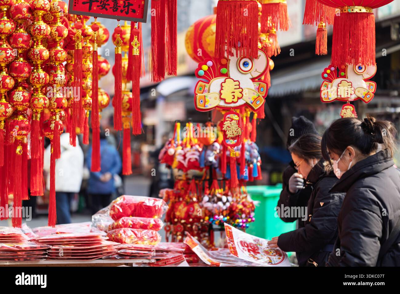 Citizens select New Year decorations at a supermarket in Nanjing City ...
