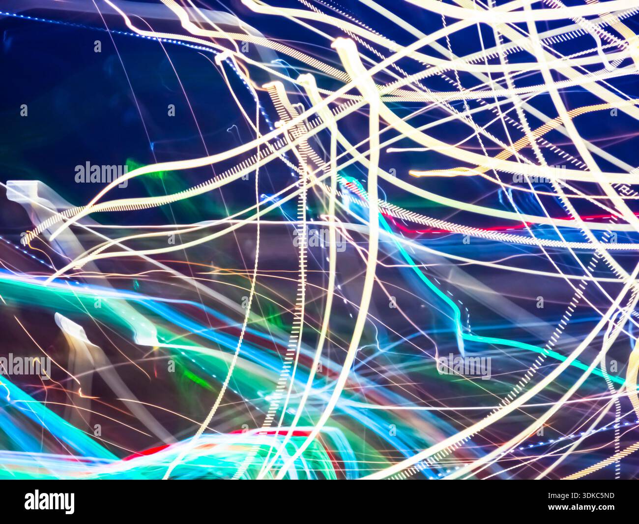 Intersecting and intertwining light streaks in white, blue, green, and ...