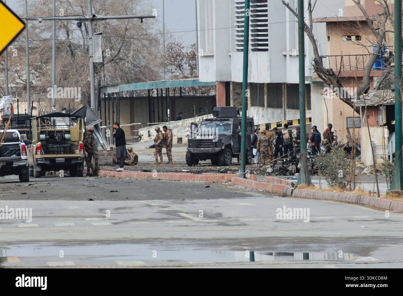 Pakistani army soldiers and other security officials examine a site ...