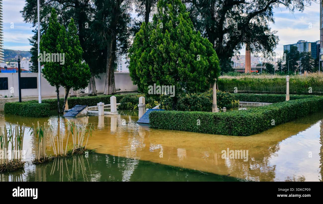 A public park and memorial area submerged in muddy floodwaters ...