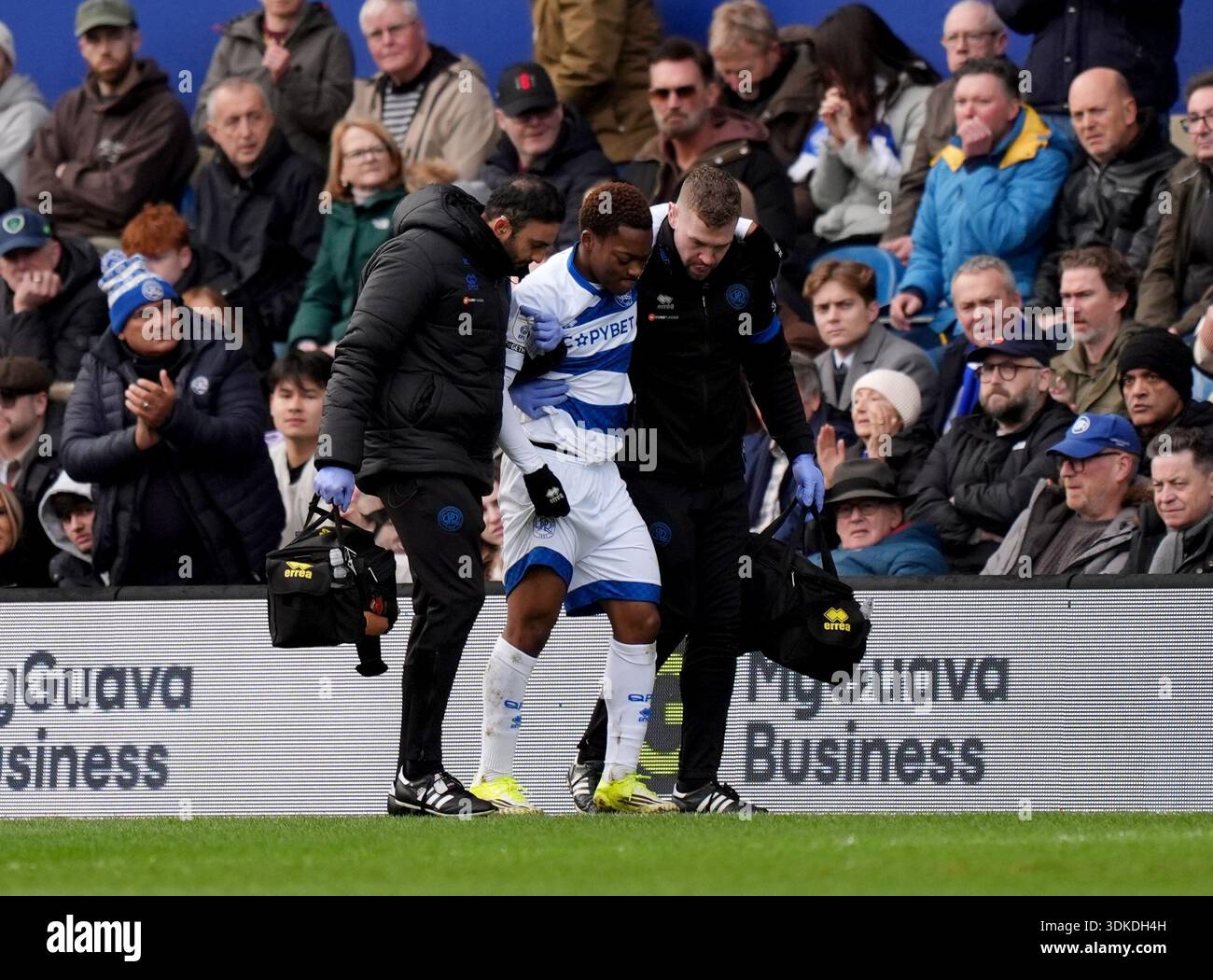 Queens Park Rangers' Karamoko Dembele is helped from the pitch after ...