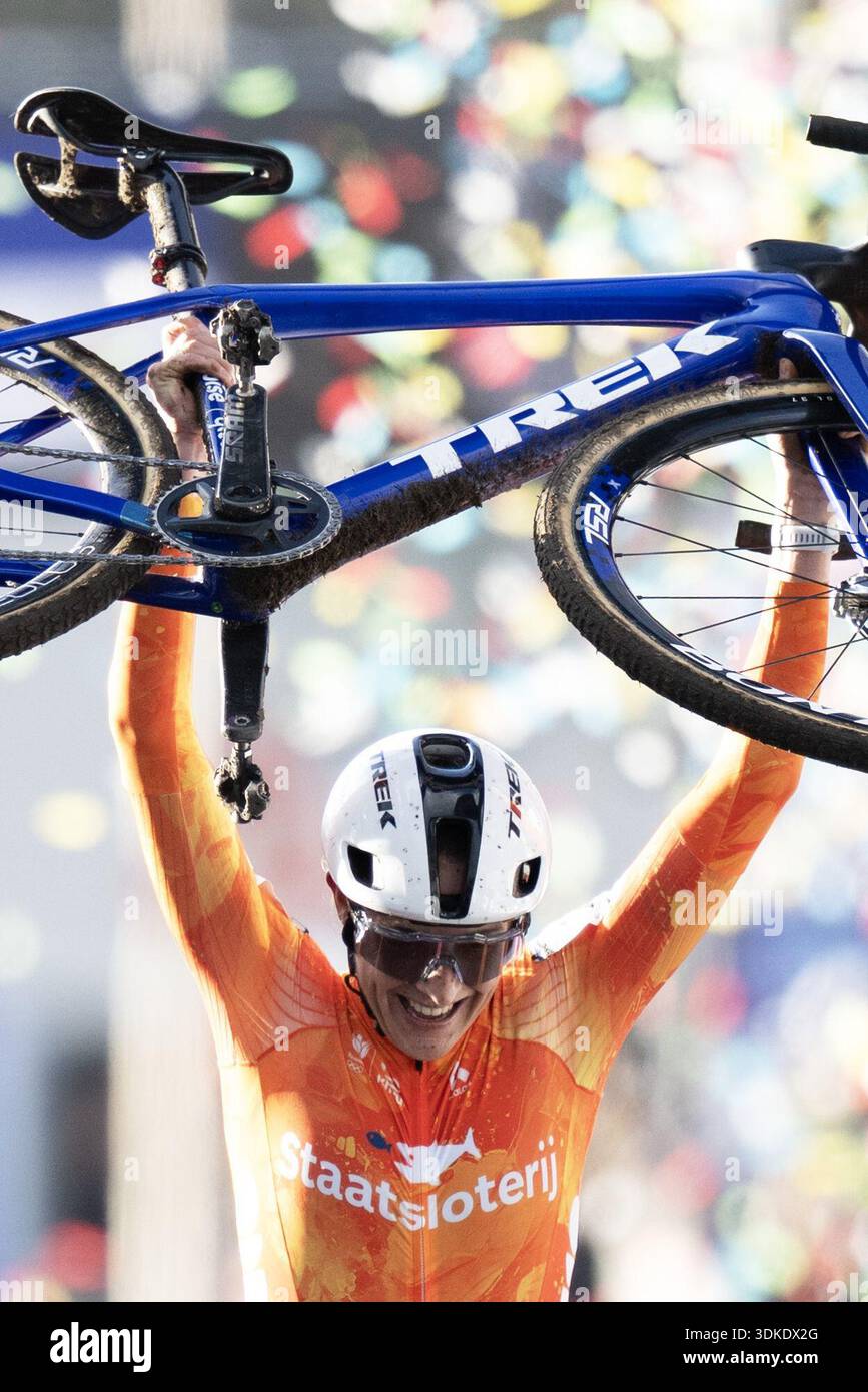 Dutch Lucinda Brand celebrates as she crosses the finish line carrying ...