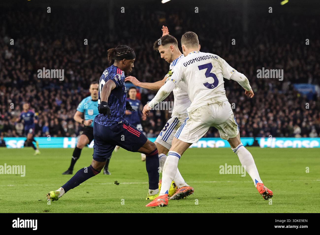 Noni Madueke of Arsenal is tackled by Anton Stach of Leeds United ...