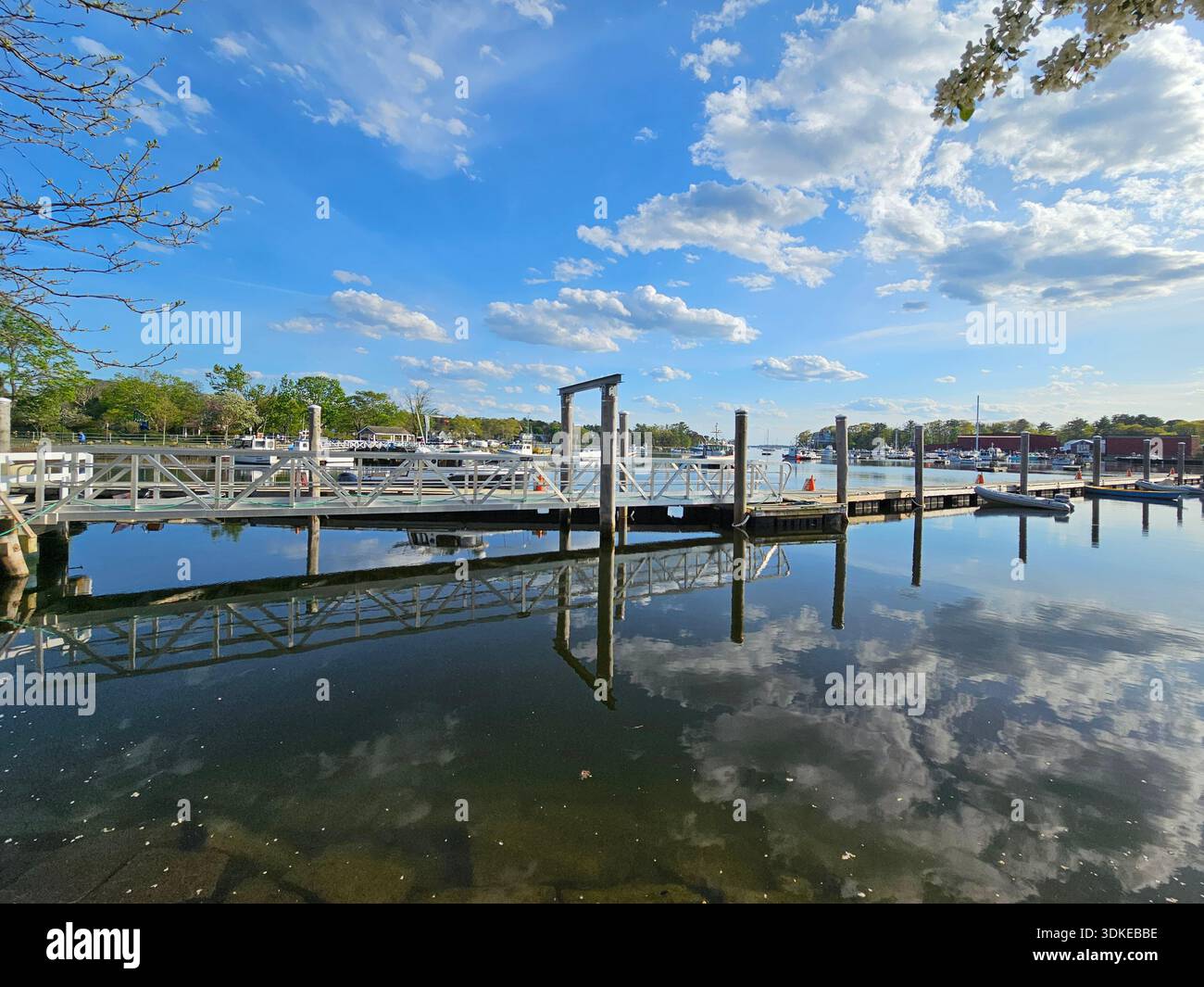 Dock Reflections on Calm Blue Water Stock Photo - Alamy