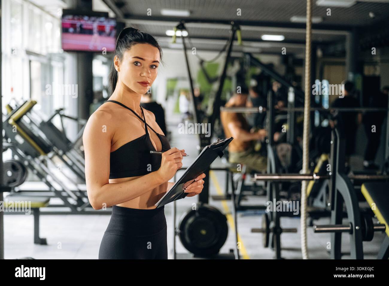 Notepad female trainer standing hi-res stock photography and images - Alamy
