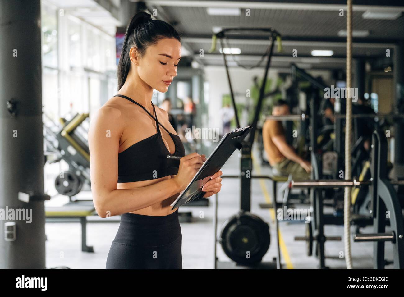 Notepad female trainer standing hi-res stock photography and images - Alamy