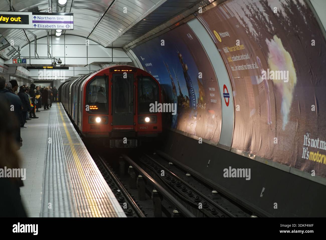 Red Northern line Tube train arriving at crowded London Underground ...
