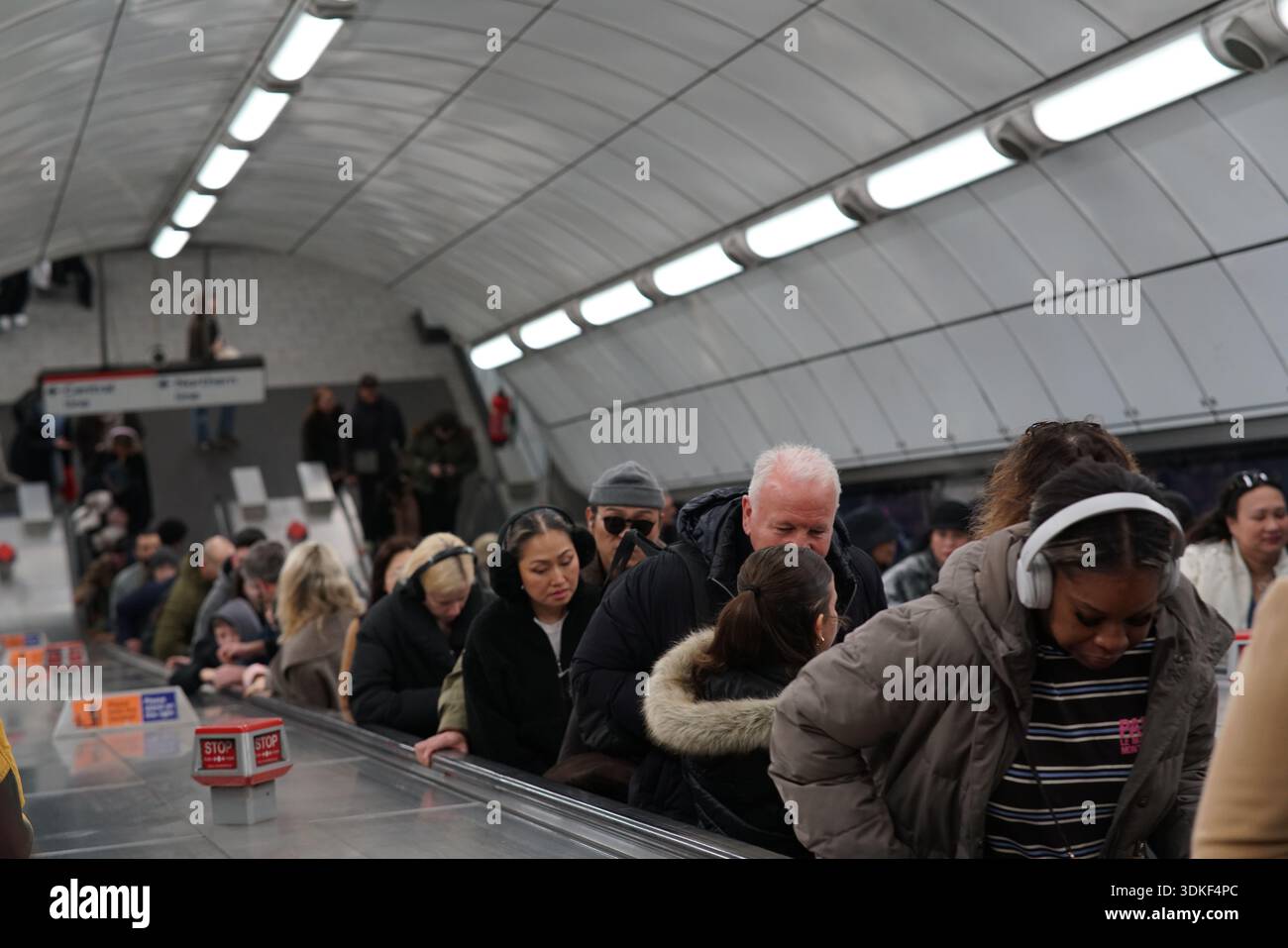 Crowded descent escalator hi-res stock photography and images - Alamy
