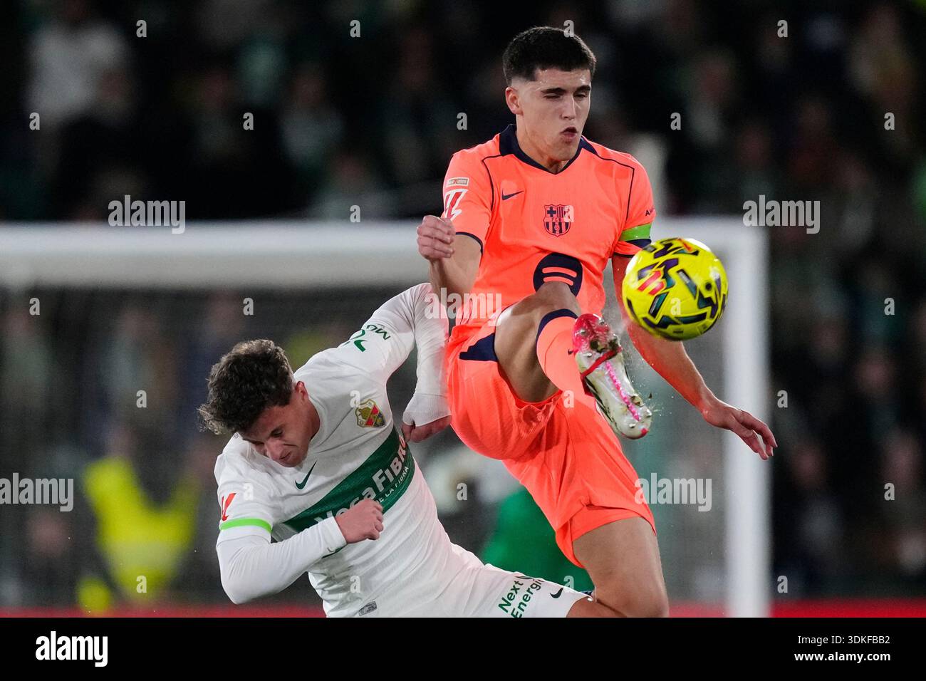 Barcelona's Pau Cubarsi, right, fights for the ball with Elche's German ...
