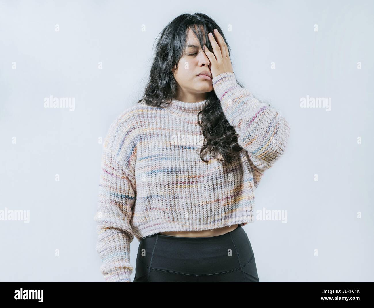 Exhausted young woman putting the palm on his face isolated. Tired and ...