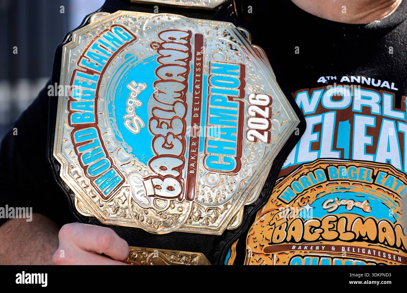 Defending champion Joey Chestnut holds his title belt after winning the ...