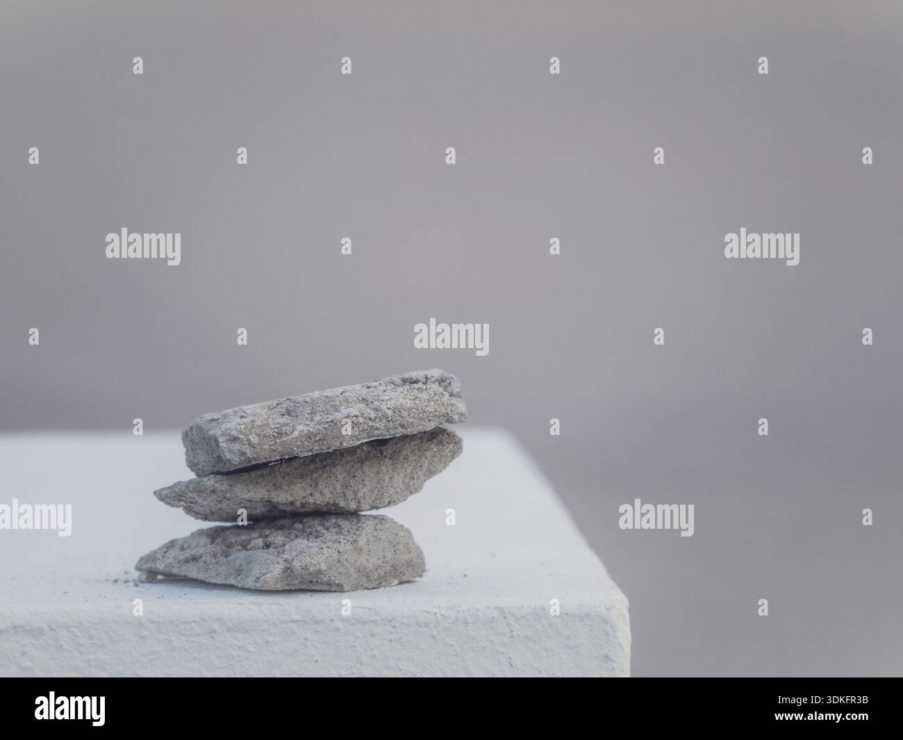 Three rough stones placed on top of each other Stock Photo - Alamy