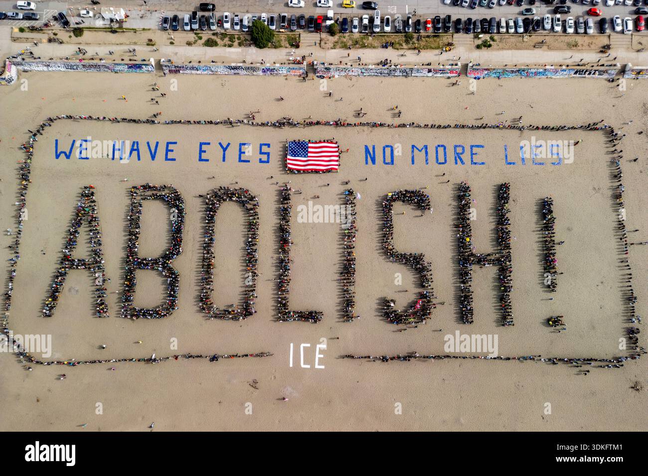 In an aerial view, protesters form a human banner on Ocean Beach during ...