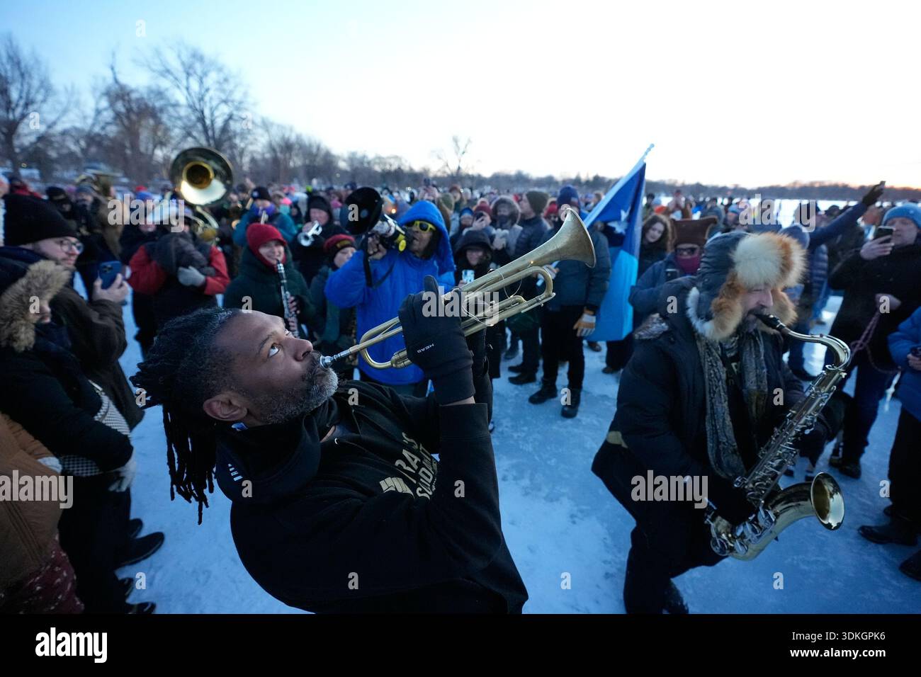 Trumpeters play while activists light candles on frozen Lake spelling ...