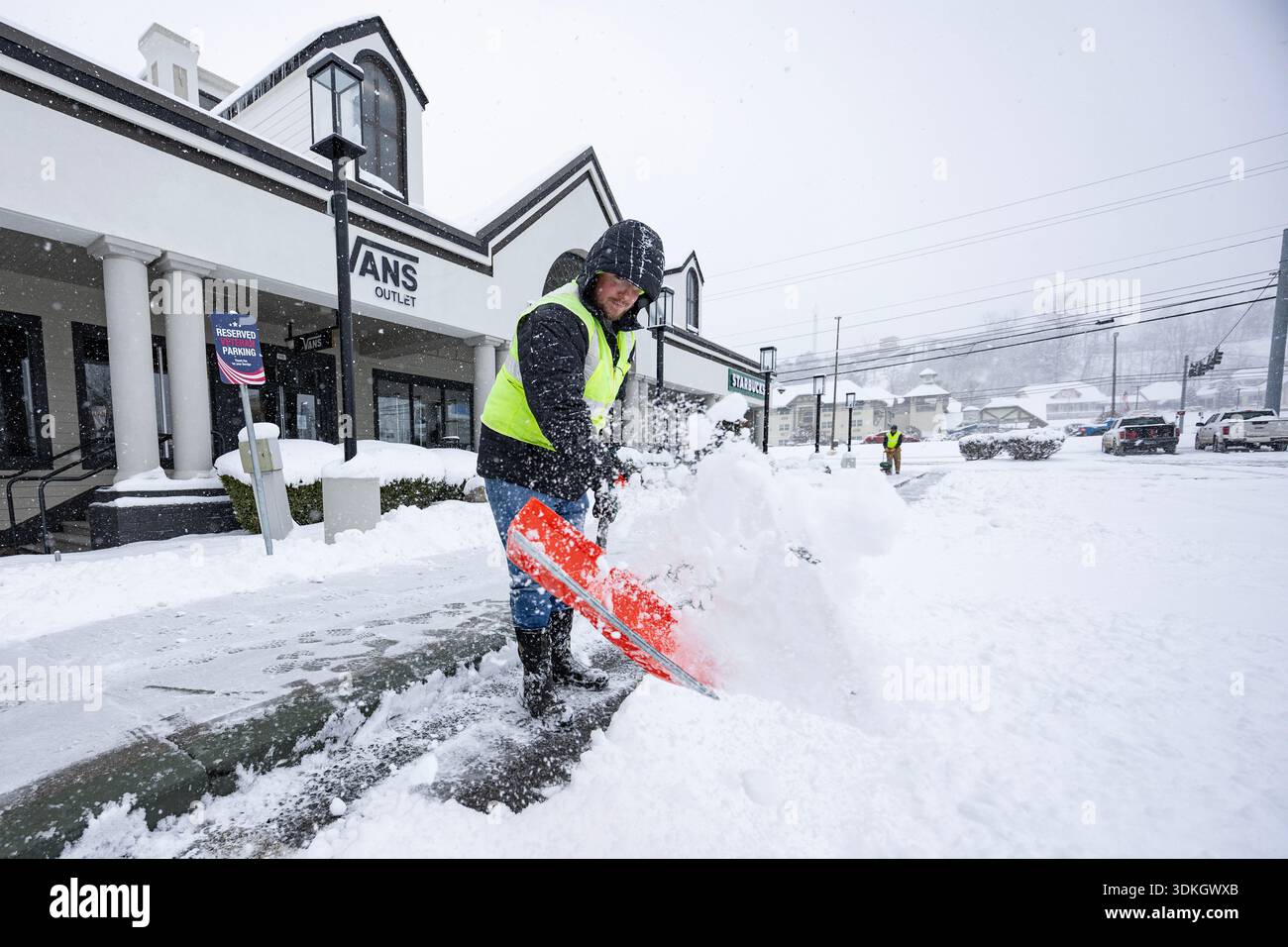 Landon Collins shovels snow in the parking lot of Tanger Outlet Mall ...