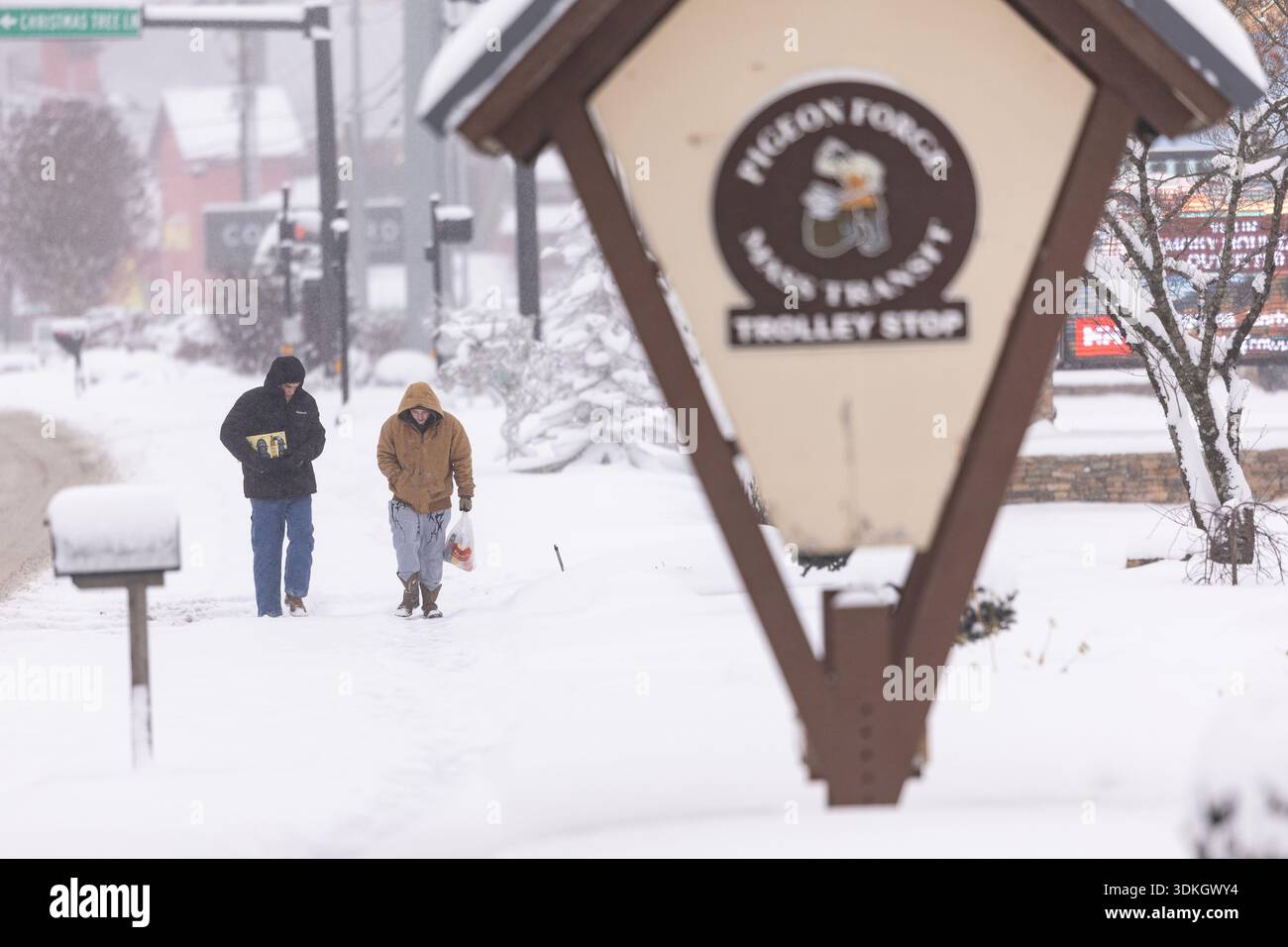 Two men walk through the snow along the parkway Saturday, Jan. 31, 2026 ...