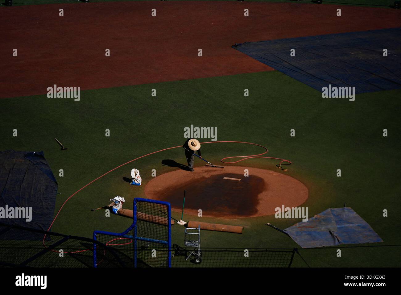 A groundskeeper prepares the pen a day ahead of the Caribbean Series ...
