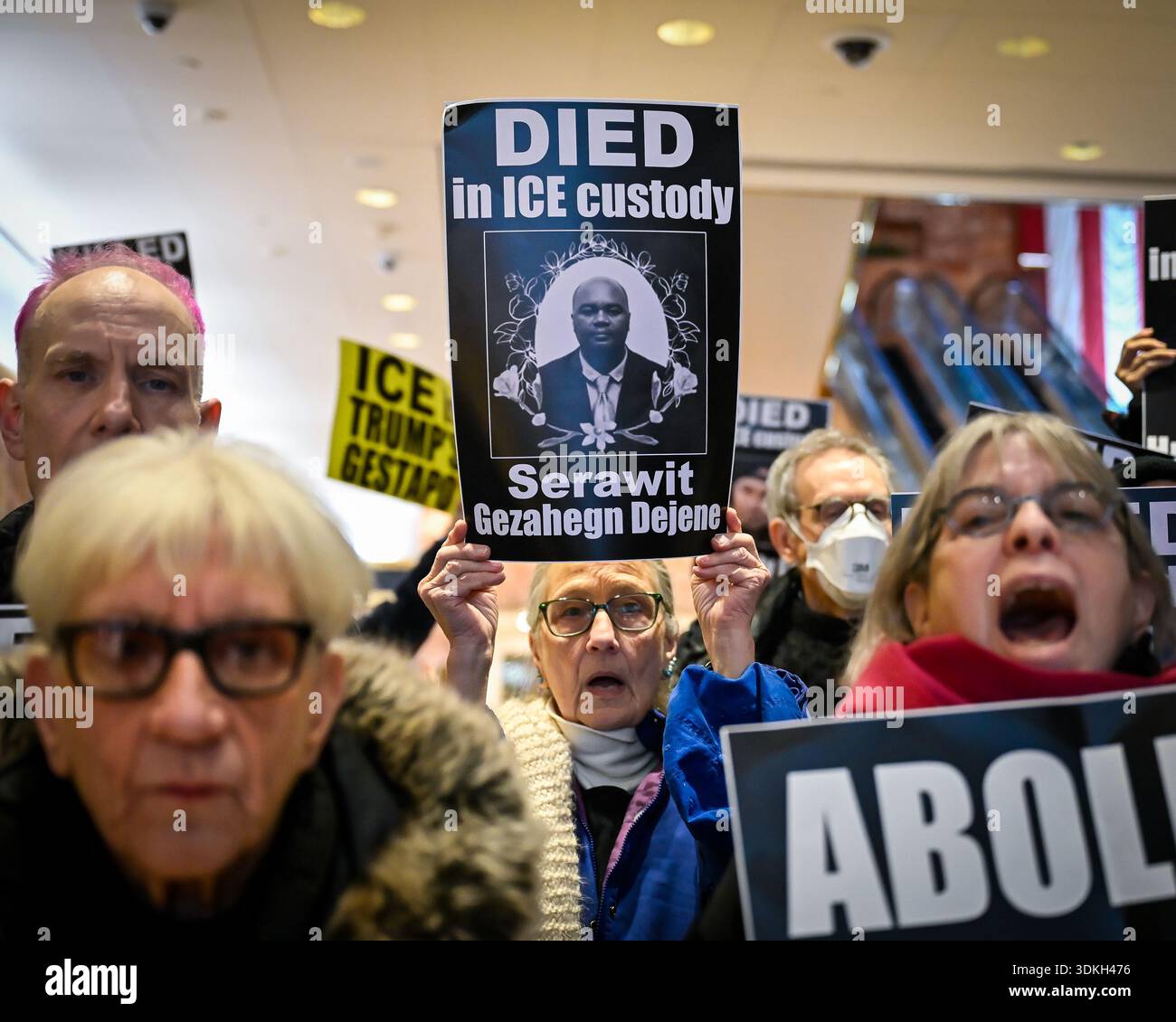 Holding up posters with the images of victims who were killed by ...