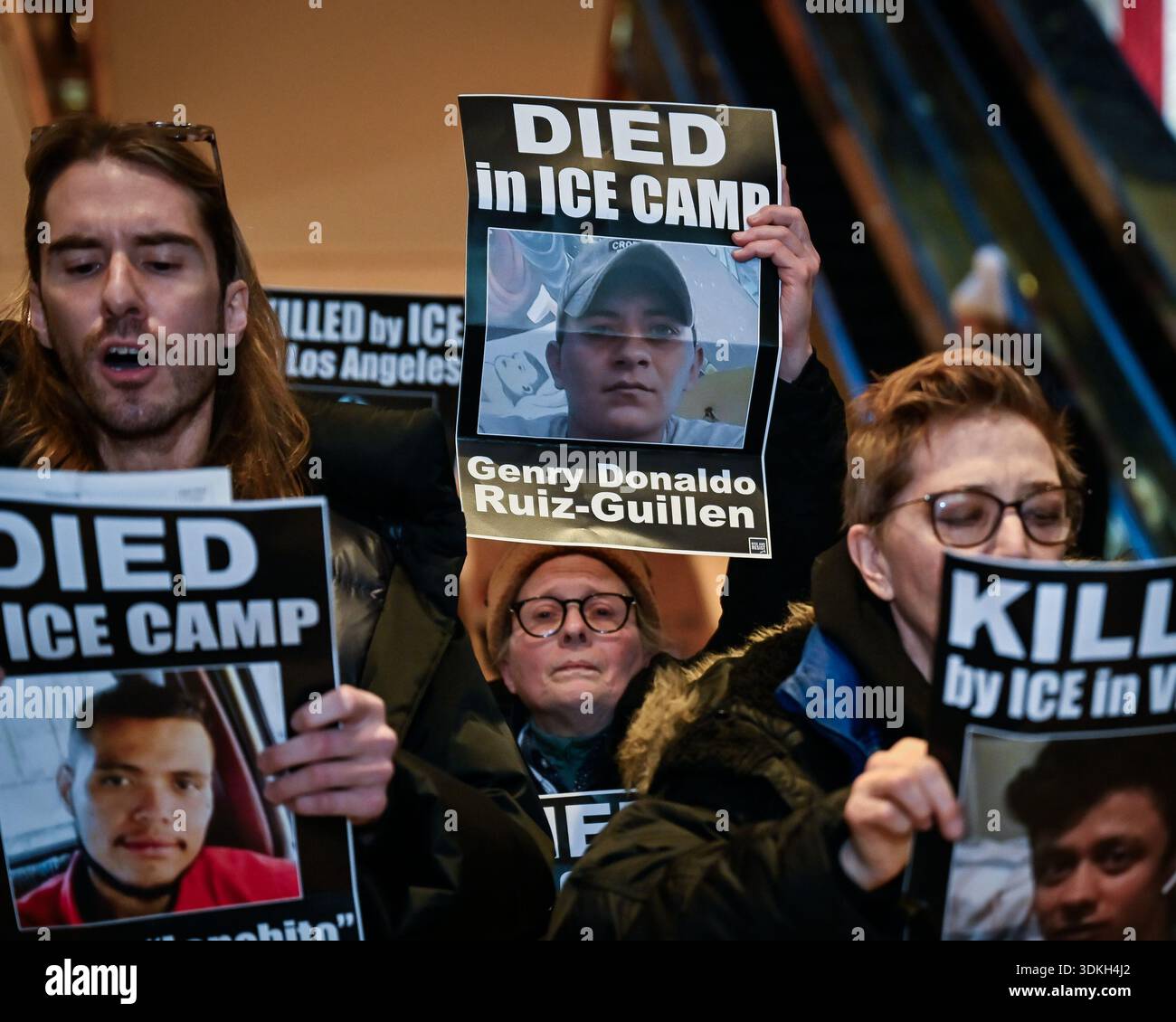 Holding up posters with the images of victims who were killed by ...