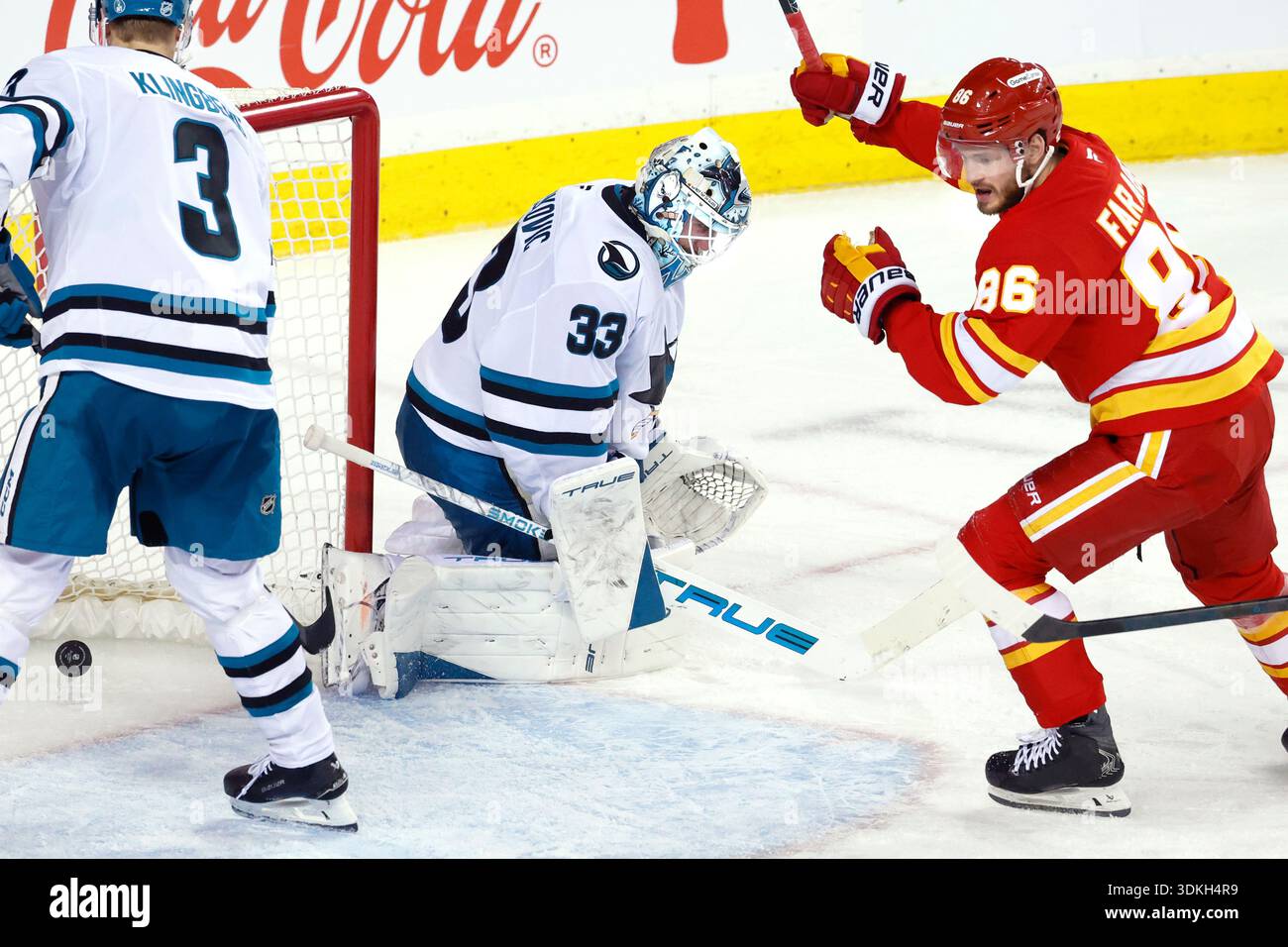 Calgary Flames' Joel Farabee, right, scores on San Jose Sharks goalie ...