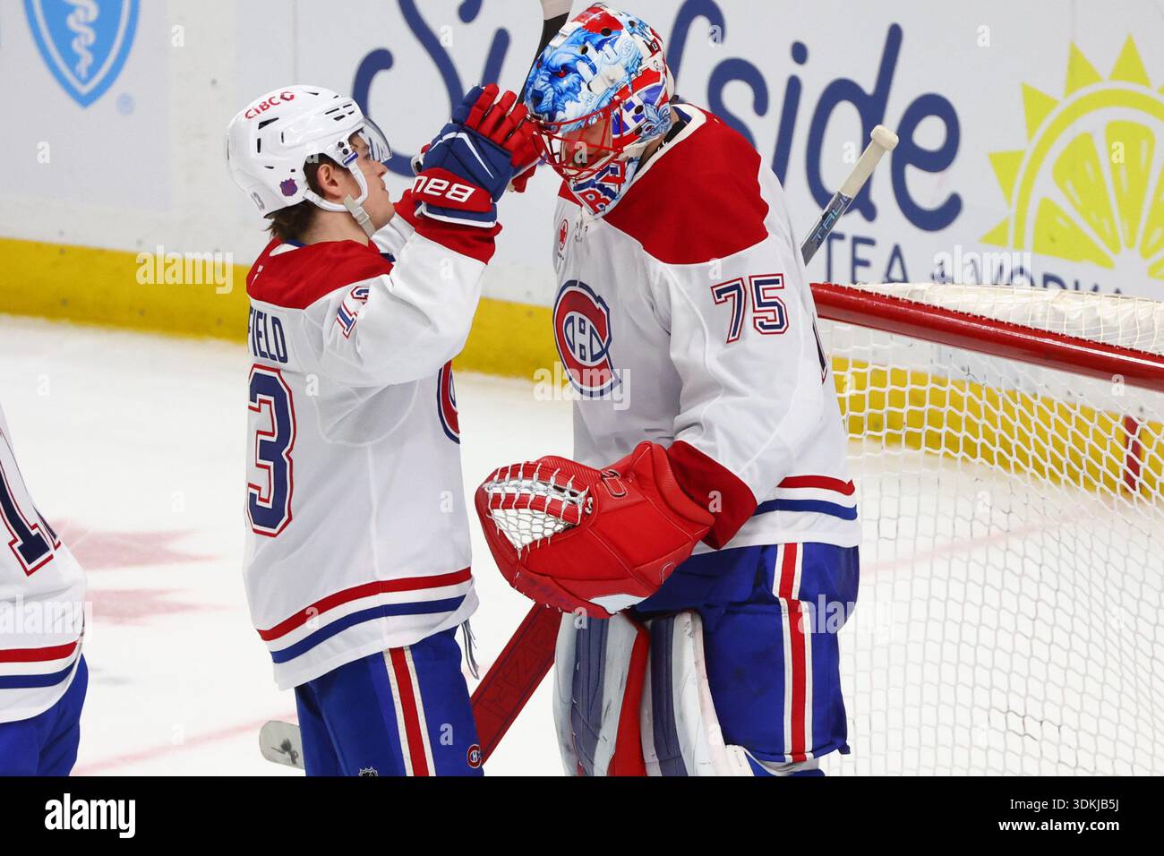 Montréal Canadiens right wing Cole Caufield, left, and goaltender Jakub ...