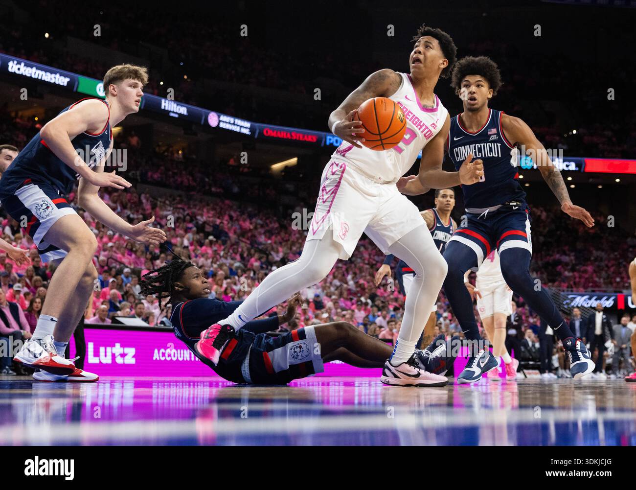 Creighton's Blake Harper, second right, drives against UConn's Eric ...