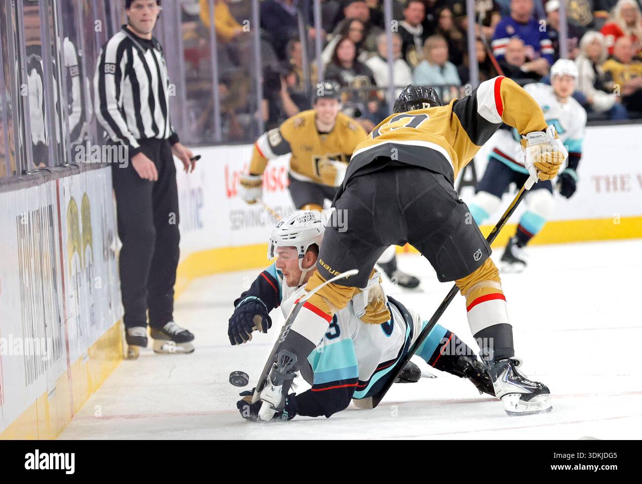 Seattle Kraken right wing Jacob Melanson, bottom, falls in front of ...